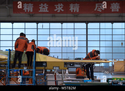 --FILE--Chinese workers assemble a Wing Loong unmanned aerial vehicle ...