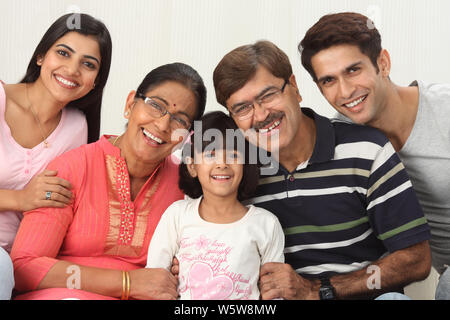 Multi generation happy Indian family standing together in backyard ...