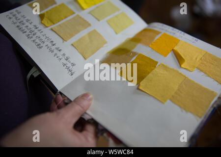 Chinese craftswoman Yuan Weilin makes an embroidery through silk ribbon ...