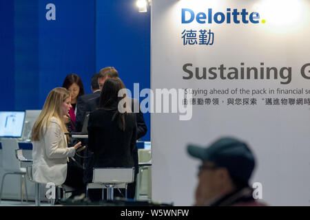 --FILE--People visit the stand of Deloitte during an exhibition in Hong Kong, China, 19 January ...