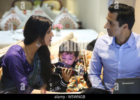 Indian man Dev Raturi, who owns eight restaurants, and his families eat ...