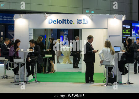 --FILE--People visit the stand of Deloitte during an exhibition in Hong Kong, China, 19 January ...