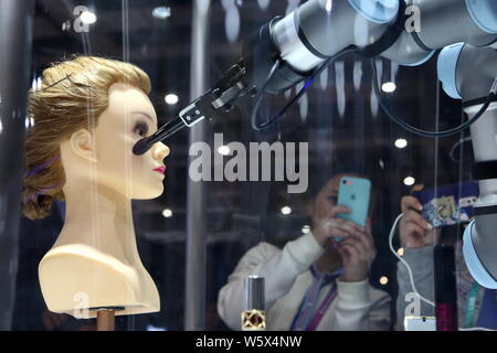 A make-up robot of L'Oreal Paris is on display during the First China ...