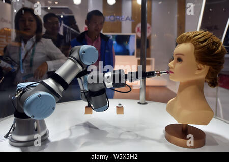 A make-up robot of L'Oreal Paris is on display during the First China ...