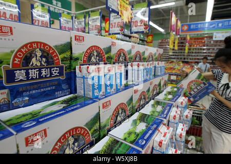 --FILE--A customer buys a carton of Bright fresh milk of Bright Food ...