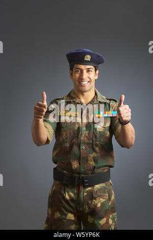 Army soldier showing thumbs up sign and smiling Stock Photo - Alamy