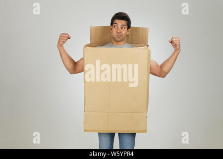 Young Man showing off his bicep muscles Stock Photo - Alamy