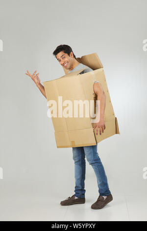 Man wearing cardboard box walking Stock Photo - Alamy
