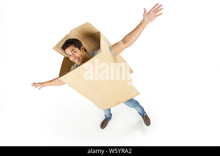 Man wearing cardboard box smiling Stock Photo - Alamy
