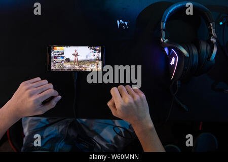 A competitor plays mobile game during the E-Sports and Music Festival ...
