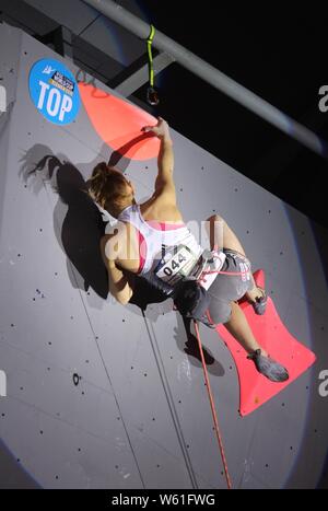 Janja Garnbret, of Slovenia, competes during the bouldering portion of ...