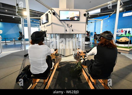 Visitors try out VR devices to ride dodgem cars at the SoReal VR ...
