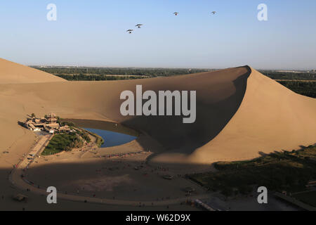 View of the Crescent Moon Lake, also known as Yueyaquan, surrounded by ...