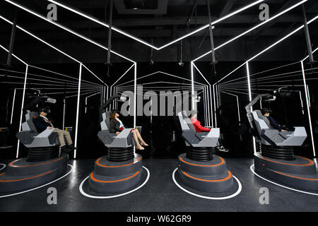 Visitors try out VR devices to ride dodgem cars at the SoReal VR ...