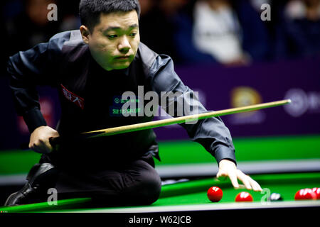 Zhao Xintong of China plays a shot against Ding Junhui of China during ...