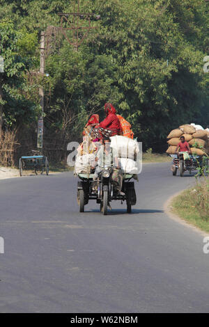 Overloaded motorcycle. Woman riding loaded motorbike with child ...