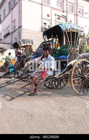 traditional hand pulled rickshaw puller pulling with passenger on ...