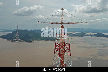 Aerial view of world's tallest transmission towers that support the 2,656-meter-long power ...