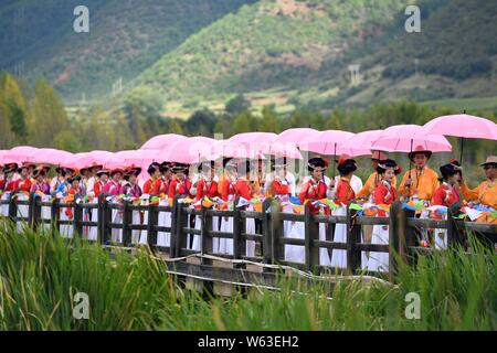 66 couples dressed in Mosuo people's traditional clothing take part in ...