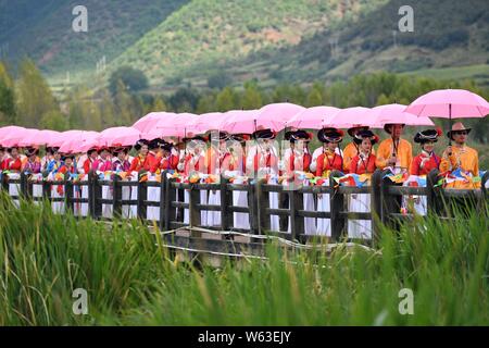 66 couples dressed in Mosuo people's traditional clothing take part in ...
