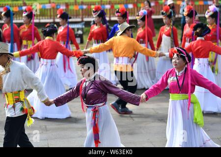 66 couples dressed in Mosuo people's traditional clothing take part in ...