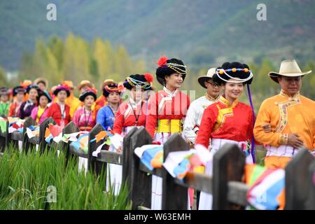 66 couples dressed in Mosuo people's traditional clothing take part in ...