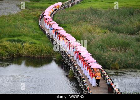 66 couples dressed in Mosuo people's traditional clothing take part in ...