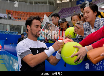 United States' Taylor Fritz signs autographs after defeating United ...