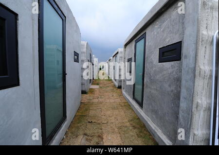 3D-printed houses are on display during the 3D Printing Industry Expo ...