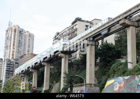 Monorail line through residential building in Chongqing, China Stock ...