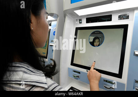 A Chinese patient has her face scanned by a self-service machine ...