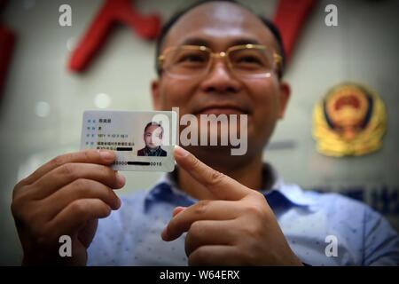 A Taiwan resident living in the Chinese mainland displays the residence ...