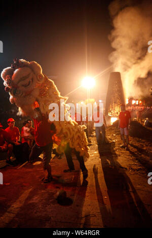 A pagoda made of tile bricks is on fire to mark the Mid-Autumn Festival ...