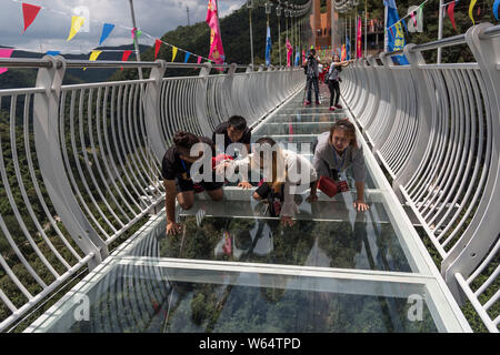 Tourists brave the 5D glass-bottom bridge over the Qinglong Valley in ...