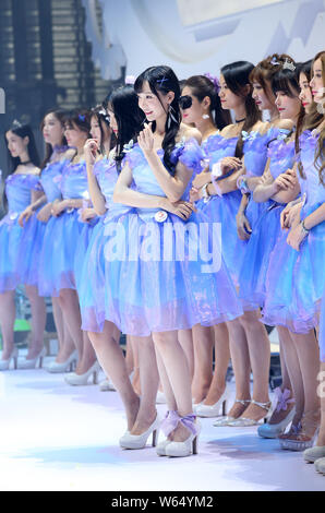 Chinese showgirls pose at the stand of Shanda Games during the 16th ...
