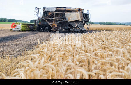 Burnt out combine harvester in field Stock Photo - Alamy