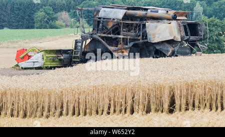 Burnt out combine harvester in field Stock Photo - Alamy