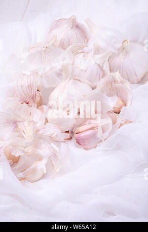 garlic, garlic cloves, garlic husks close-up on a white background with ...