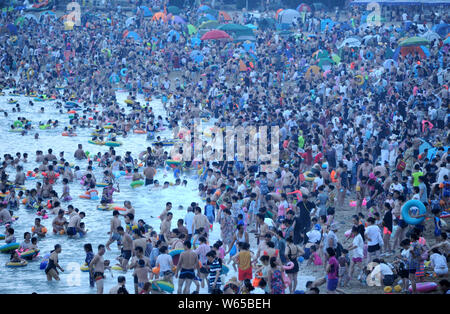 More than 40,000 holidaymakers flock to a beach resort to cool off on a ...