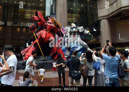 The 6-meter-tall statues of Nu Gundam and Sazabi are on display during ...