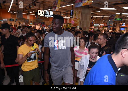NBA star Clint Capela, center, of Houston Rockets takes selfies with ...
