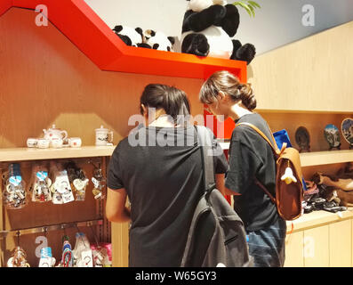 Customers choose souvenirs at the Giant Panda House Shop in Beijing Zoo ...