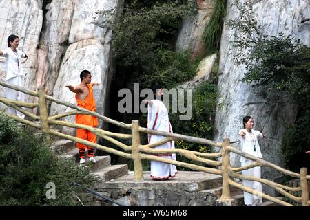 In this aerial view, Yoga lovers practice yoga and Shaolin students ...
