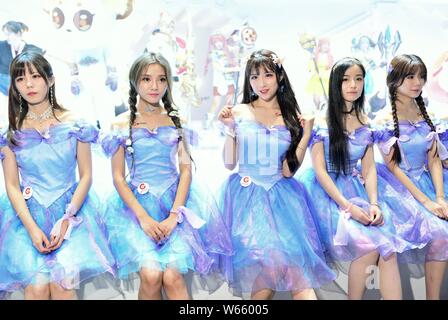 Chinese showgirls pose at the stand of Shanda Games during the 16th ...