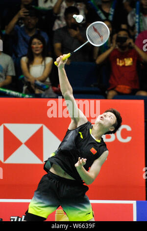 Chen Long of China serves against Huang Yuxiang of China in their first ...