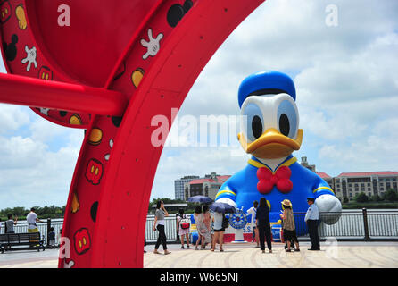 An 11-meter-tall inflatable Donald Duck is on display at the lakeside ...