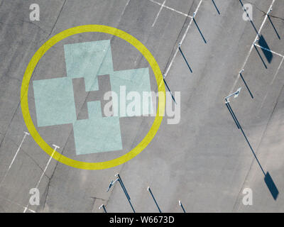 Concrete helicopter landing pad on the top of a building. Shapes of ...