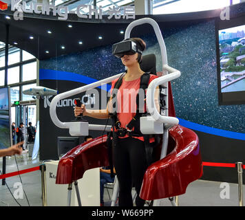 A visitor tries out a science and technology exhibit in the Hefei ...