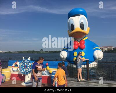 An 11-meter-tall inflatable Donald Duck is on display at the lakeside ...