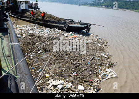 Chinese workers collect garbage floating on the Yangtze River in ...